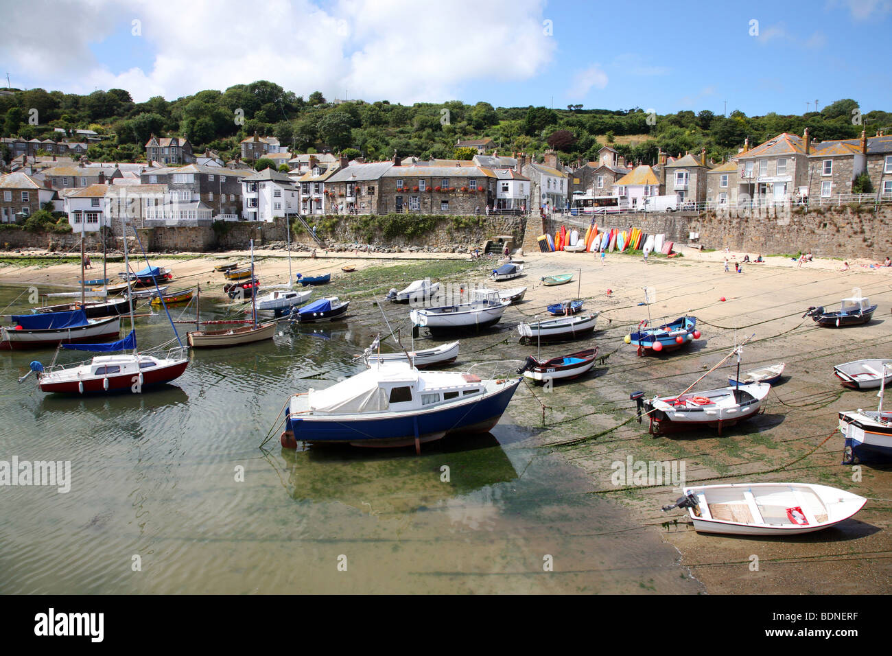 View of the harbour at the attractive fishing village of Mousehole on ...