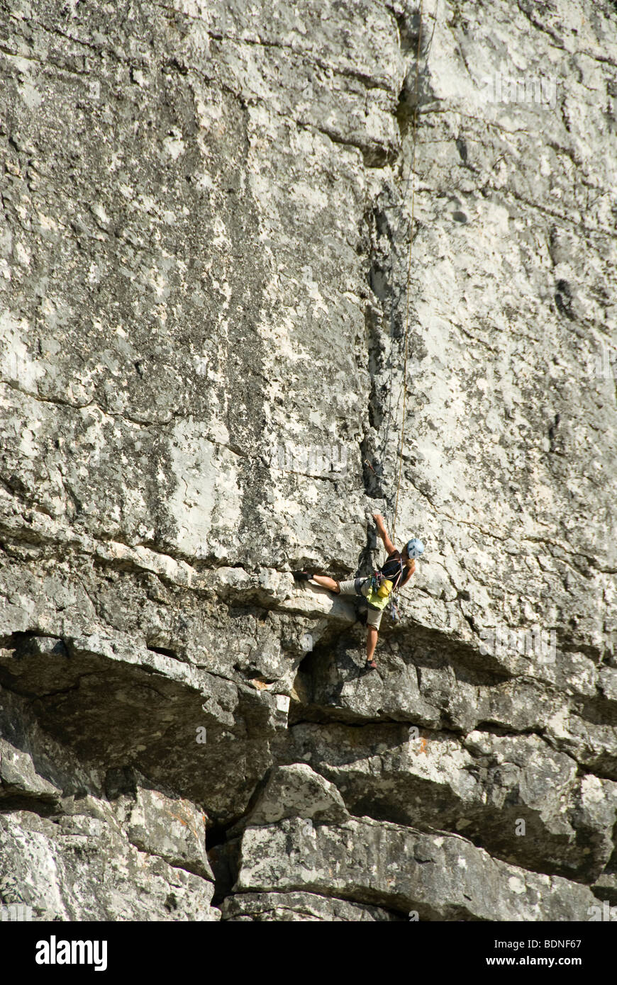 Female rock climber on cliff below cableway station, Table Mountain ...