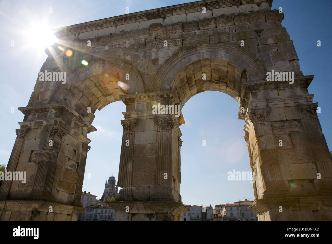 Roman port city gate Arc de Germanicus arch with cathedrale de St ...