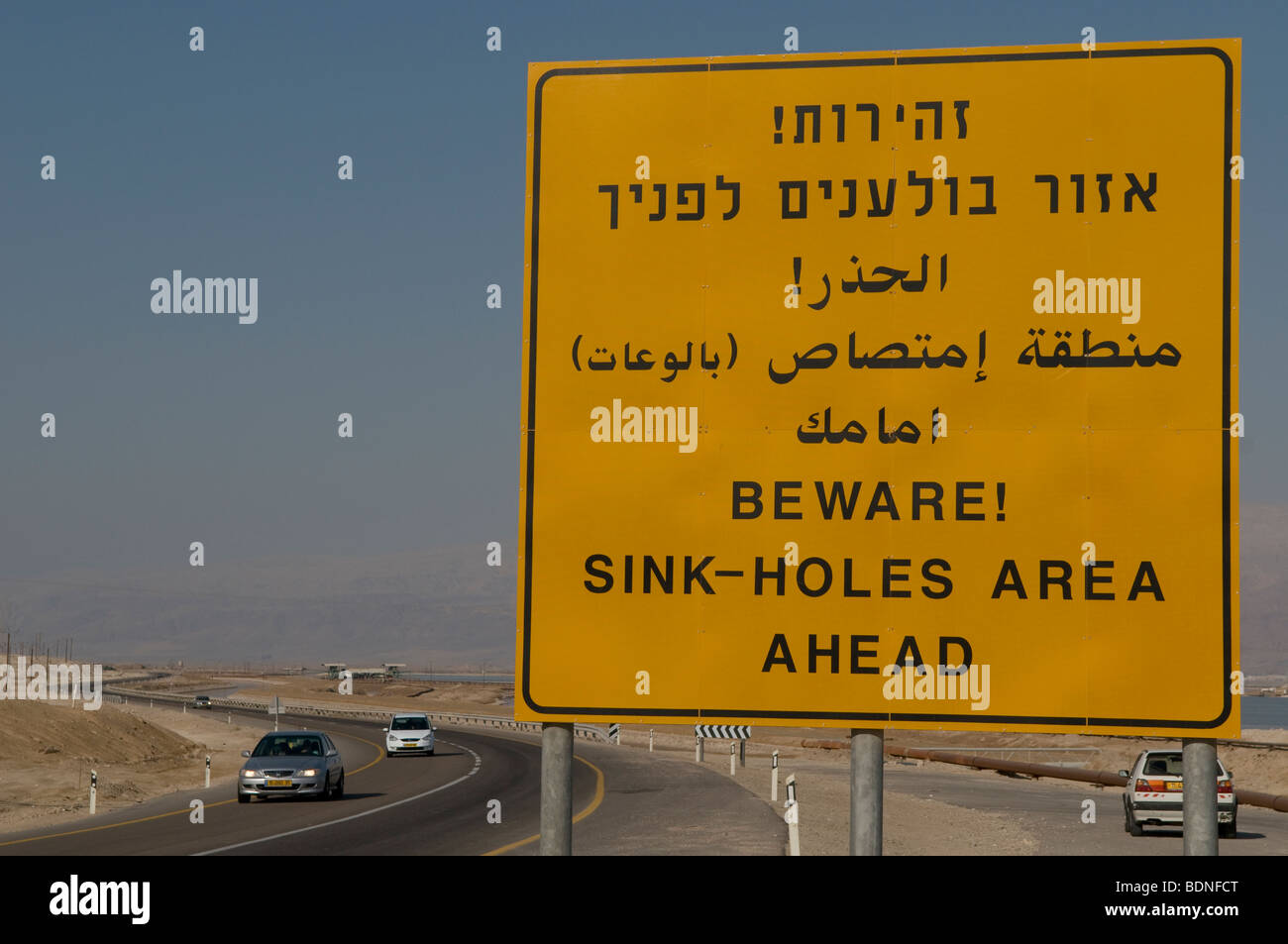 Sinkholes warning sign in highway 90 along the Dead Sea coast in Israel ...