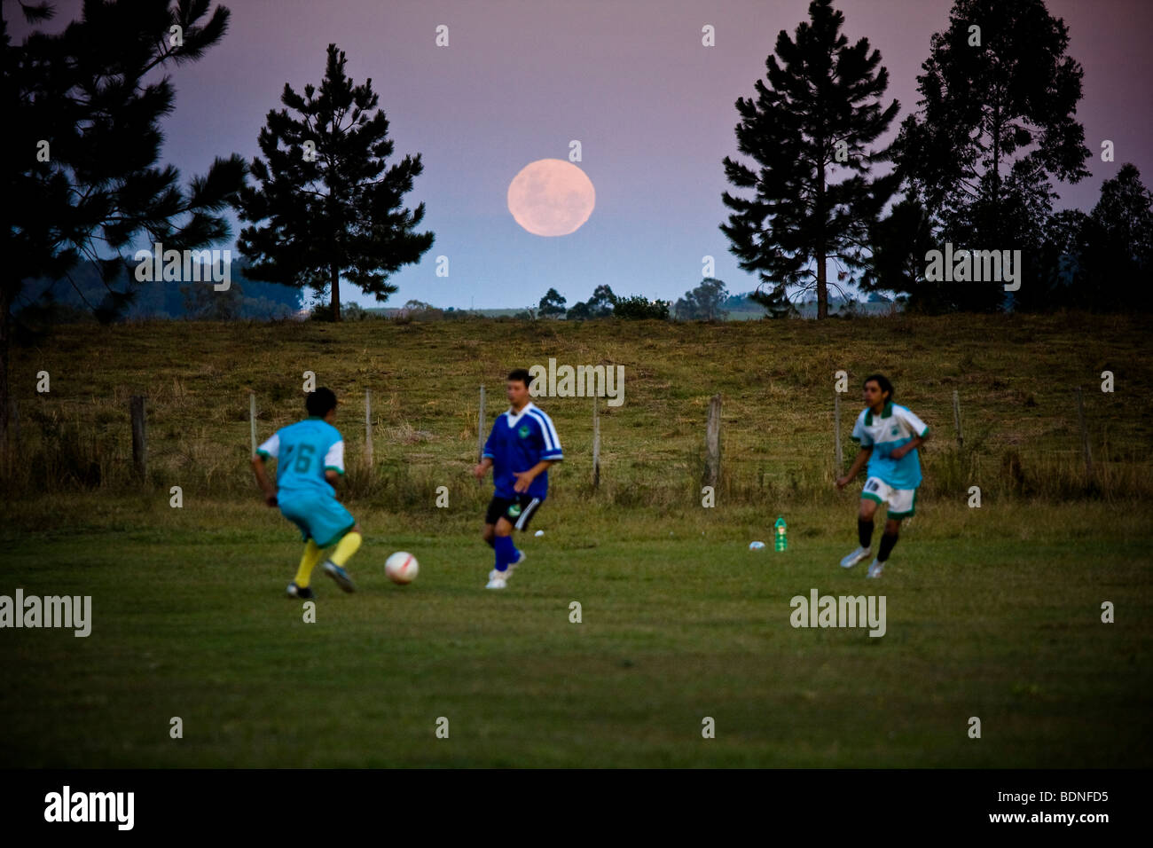 amateur soccer game with full moon rising on background Stock Photo - Alamy