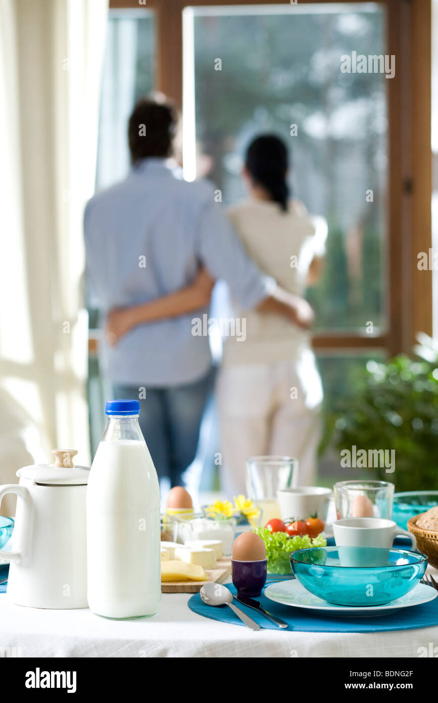 Couple looking out window Stock Photo - Alamy