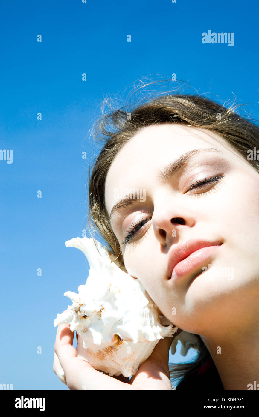 Woman holding seashell Stock Photo - Alamy