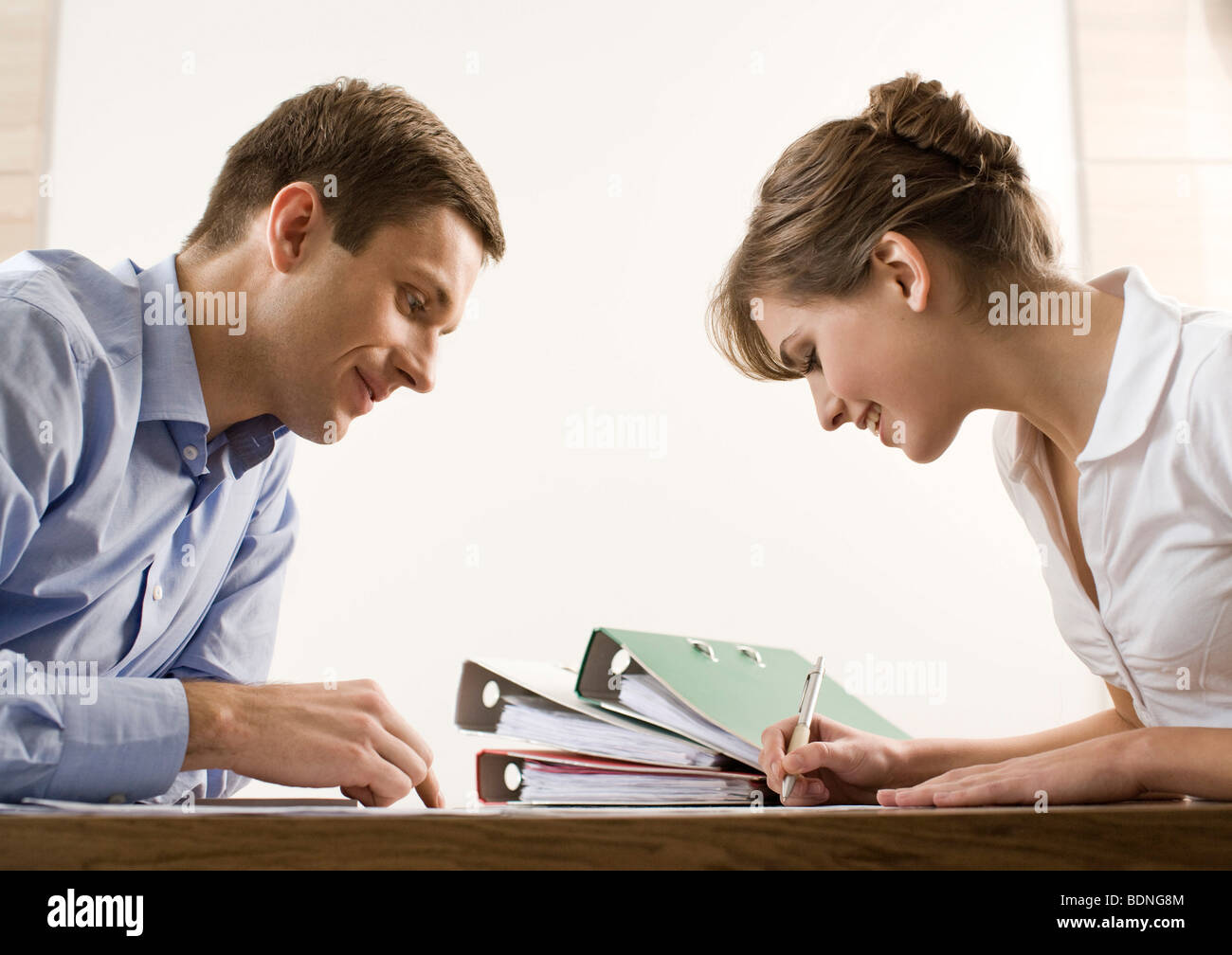 man and woman fill up documents Stock Photo - Alamy