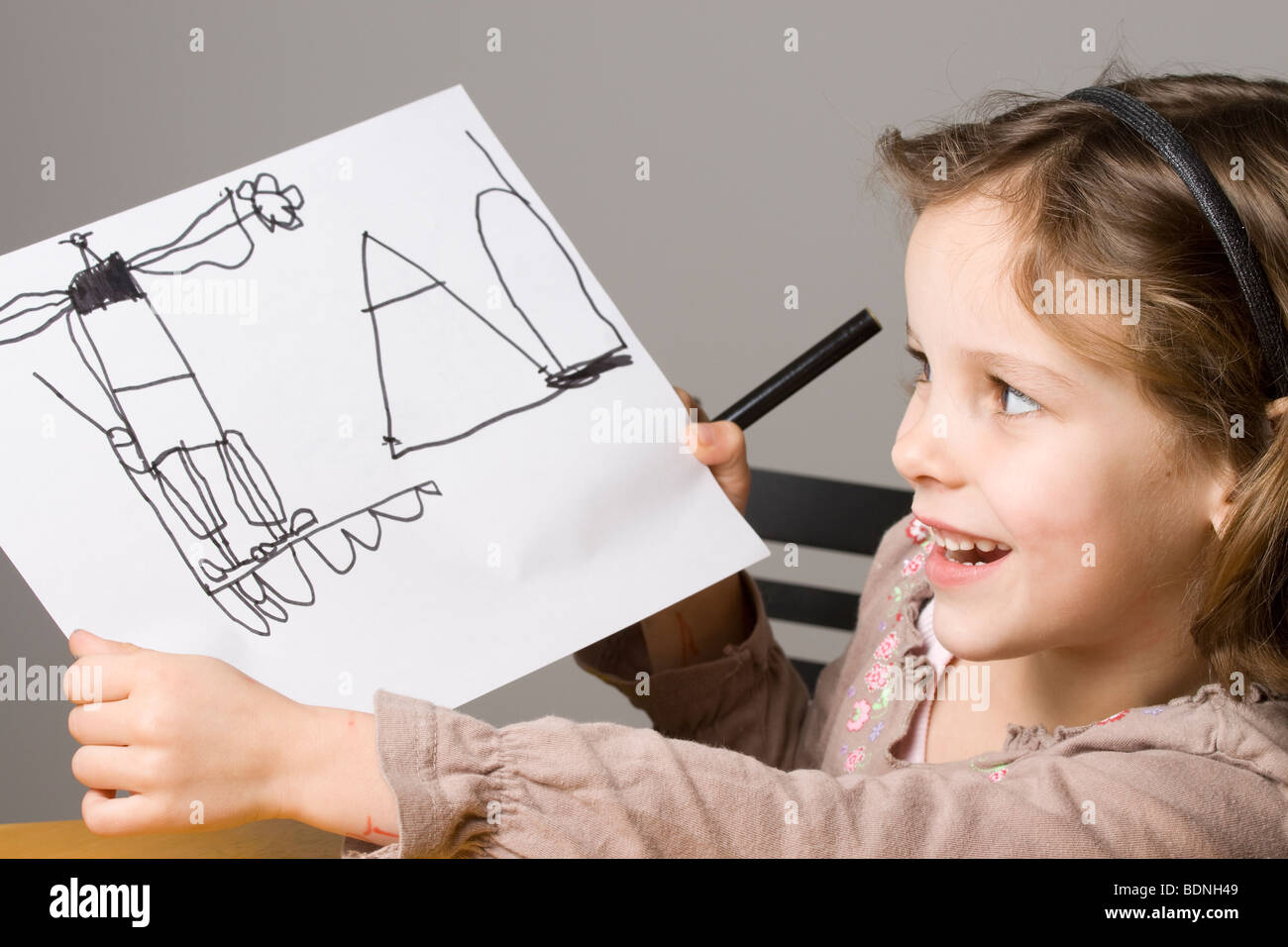 Girl showing her drawing Stock Photo - Alamy