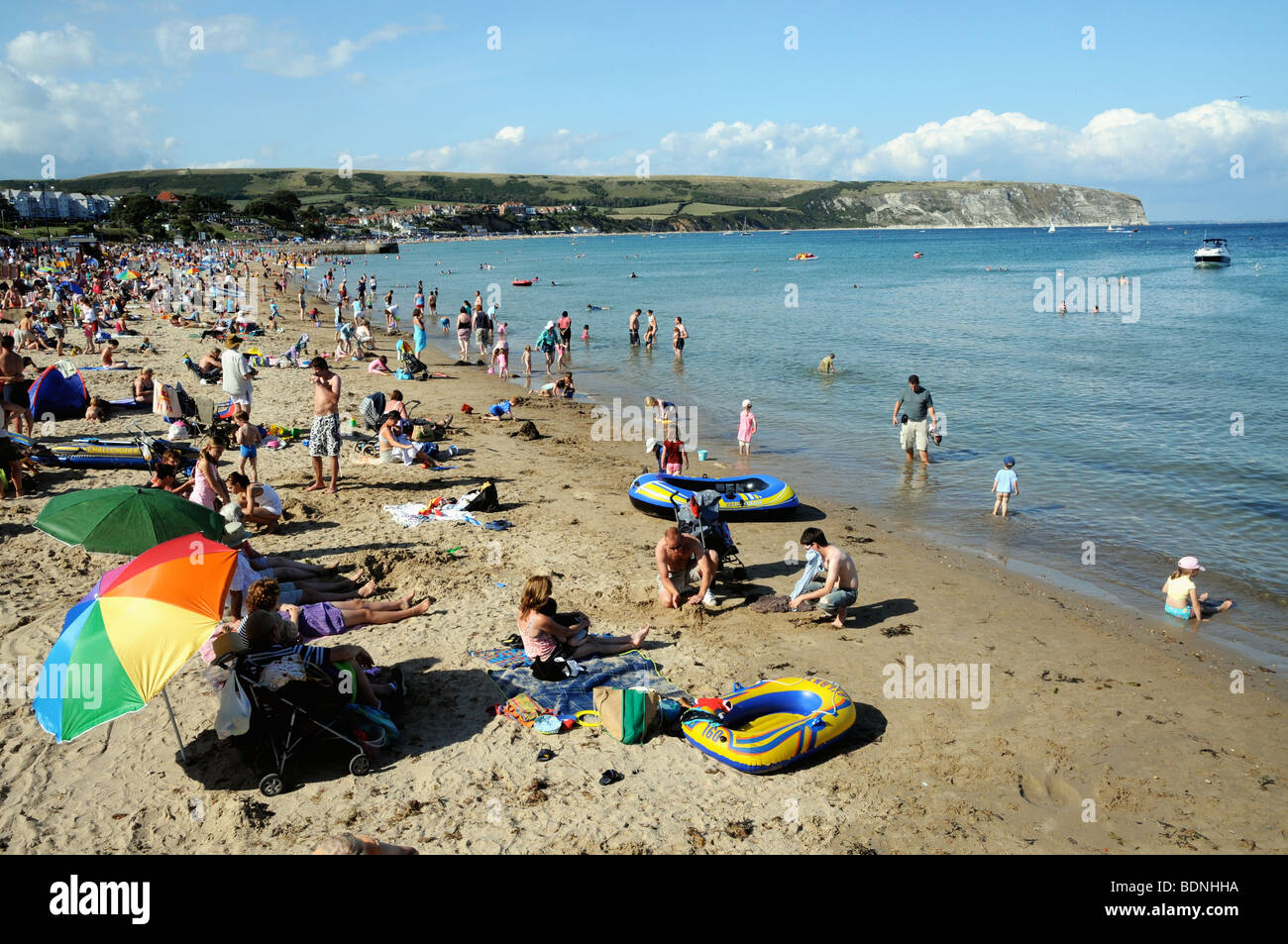 The beach on a sunny summer's day at the seaside resort of Swanage in ...