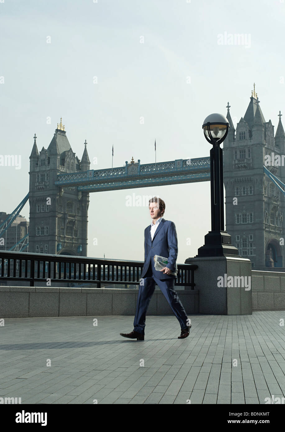 Young business man walking in front of Tower Bridge Stock Photo - Alamy