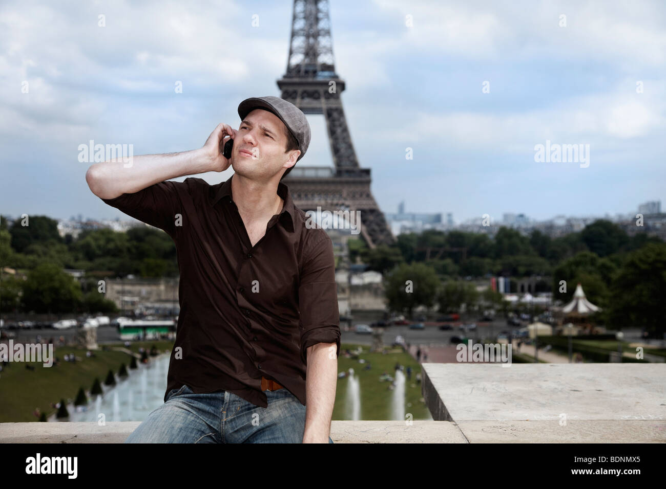 Young man in front of the Eiffel Tower, Paris, France, Europe Stock ...