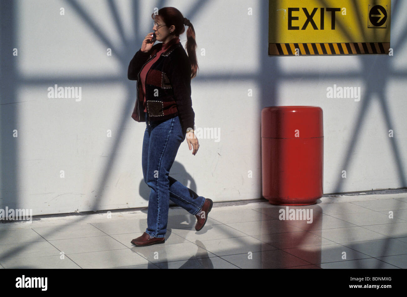 Airport passenger terminal hallway exit direction sign Stock Photo - Alamy