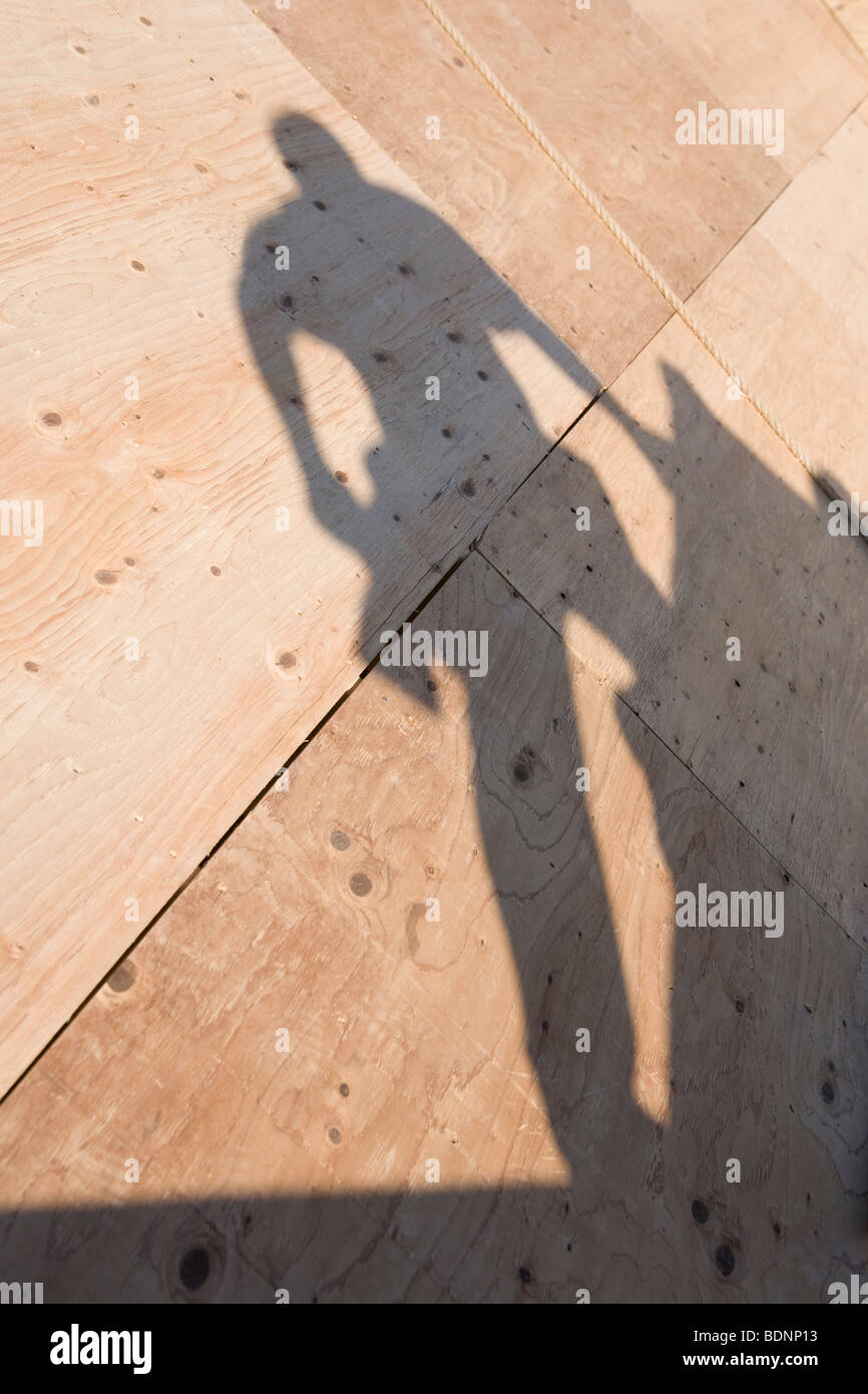 Shadow of carpenter on the roof of an under construction house Stock ...