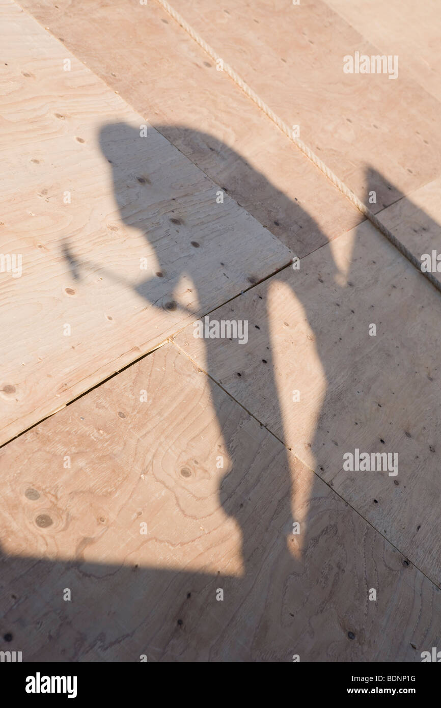 Shadow of carpenter on the roof of an under construction house Stock ...