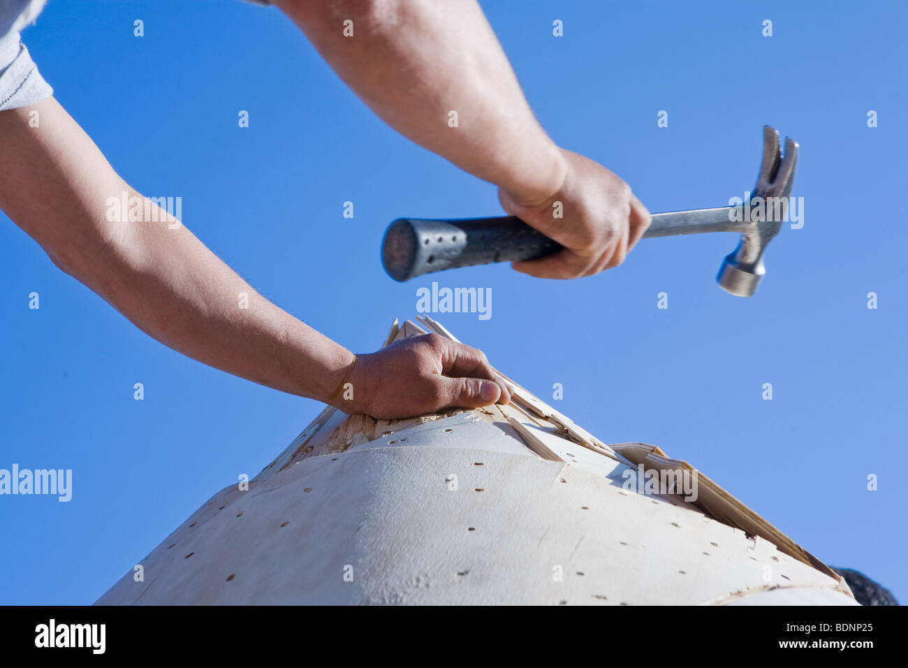 Carpenter working on the turret of a house Stock Photo - Alamy
