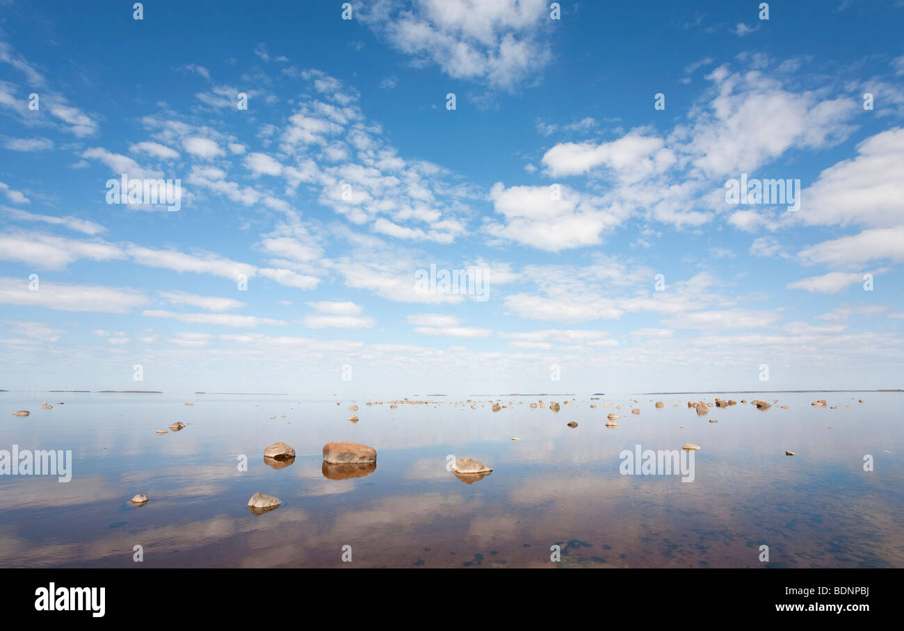 Calm sea at low tide reveals the rocky shallow shoreline at Bothnian ...