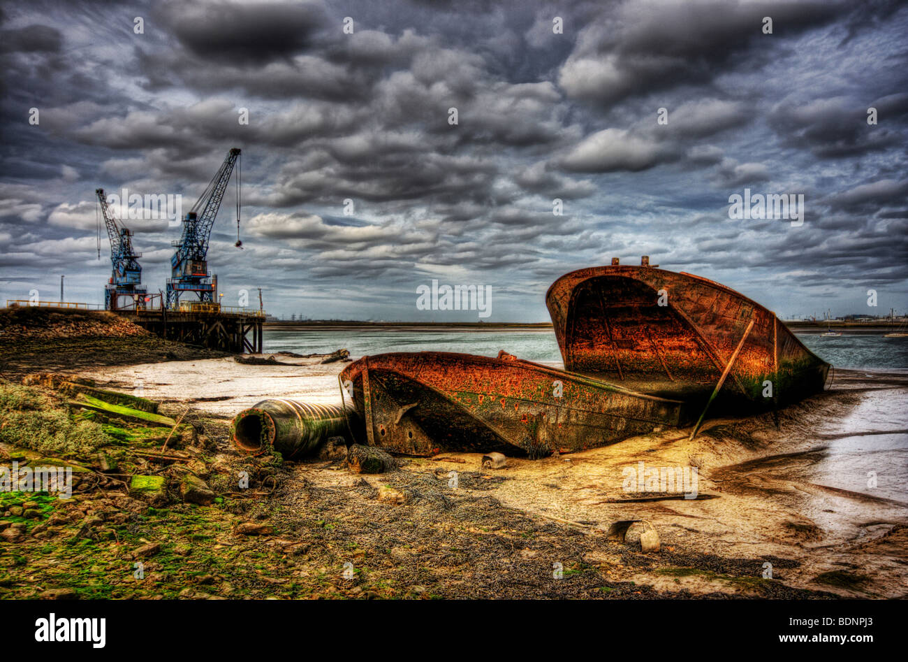 Two abandoned scrapped barges ready to be stripped of steel and beached ...
