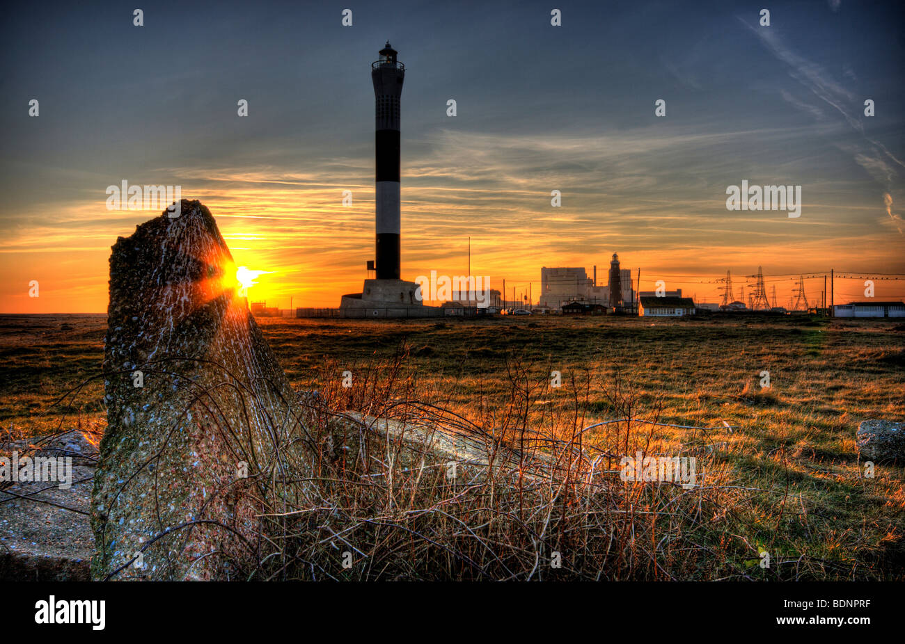 Sunset at Dungeness with both the old and new lighthouses and the ...