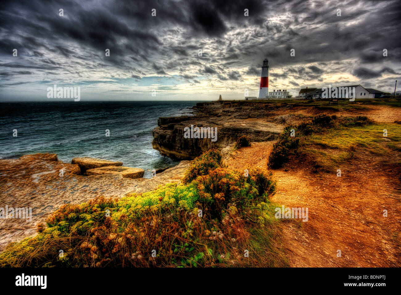 Stormy skies over the headland at Portland Bill lighthouse with ...
