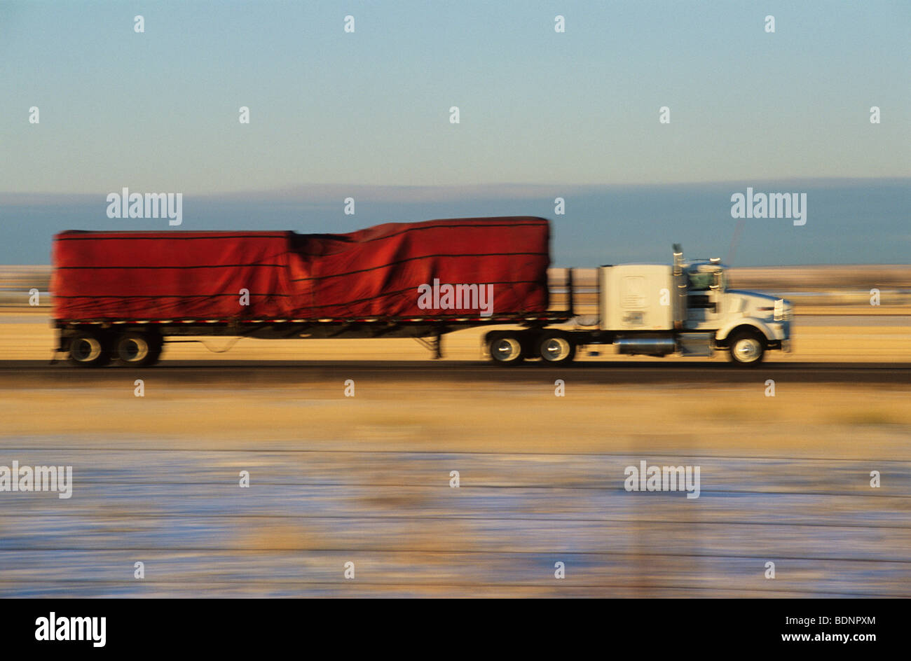 Truck on road in desert Stock Photo - Alamy
