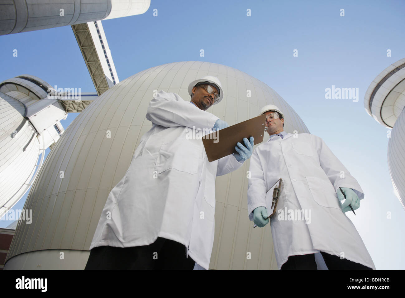Two scientists discussing a report Stock Photo - Alamy