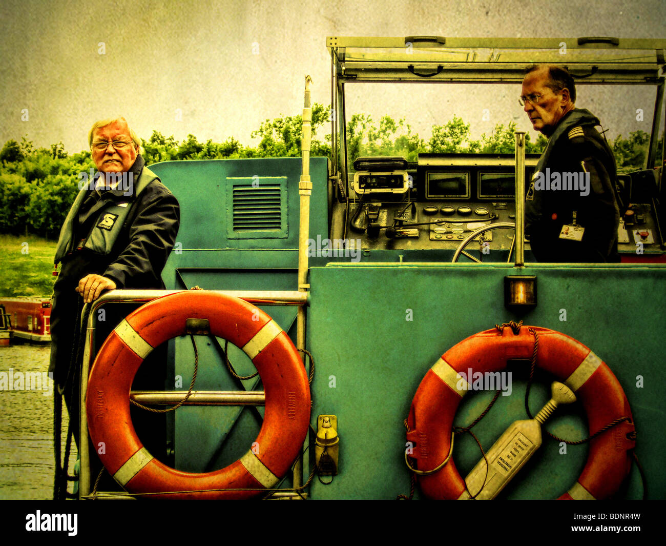 Two men standing on a boat Stock Photo - Alamy