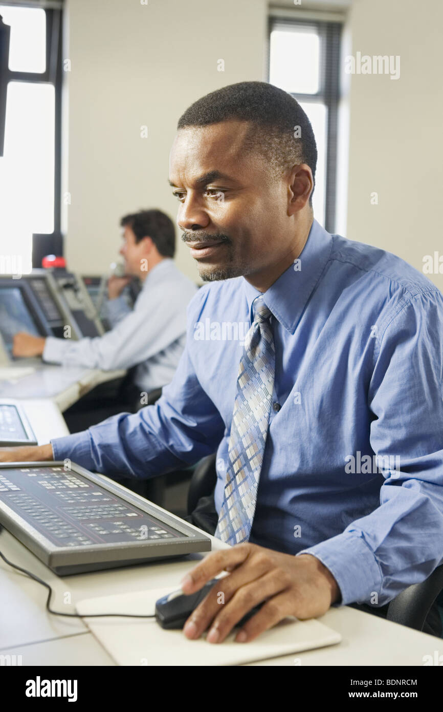 Two operating engineers working in a control room Stock Photo - Alamy