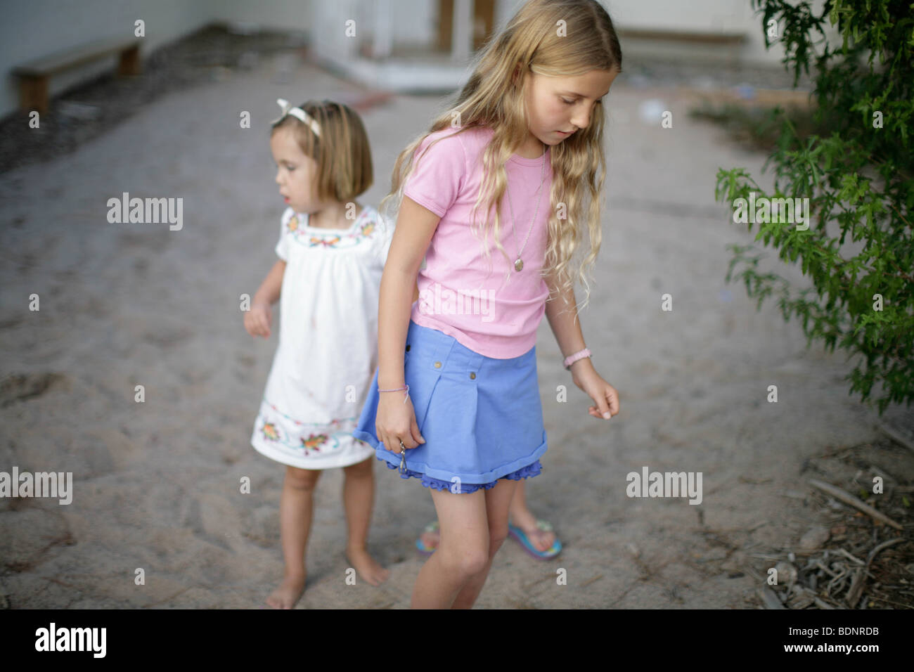 Three sisters playing outdoors Stock Photo - Alamy