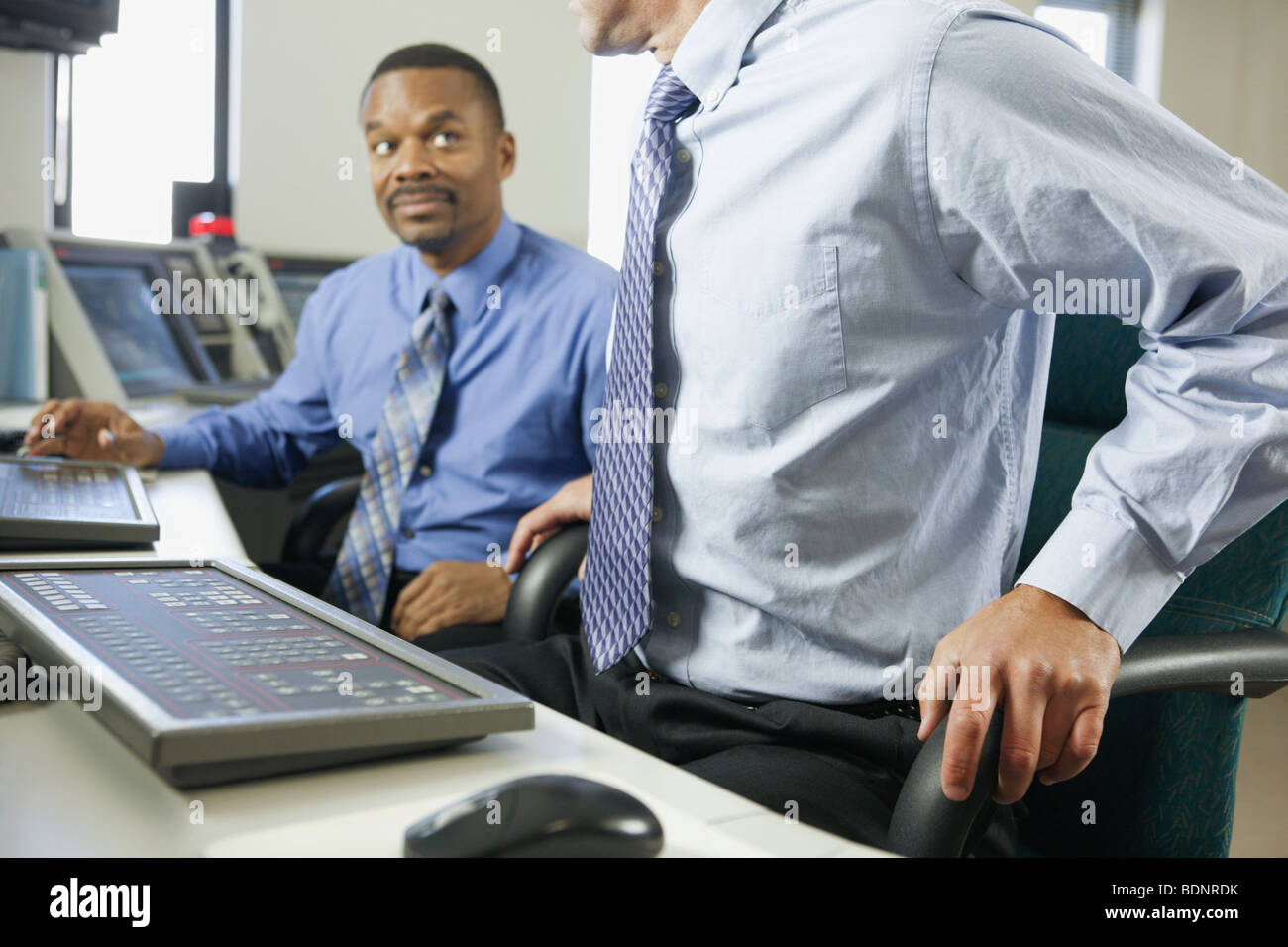 Two operating engineers working in a control room Stock Photo - Alamy