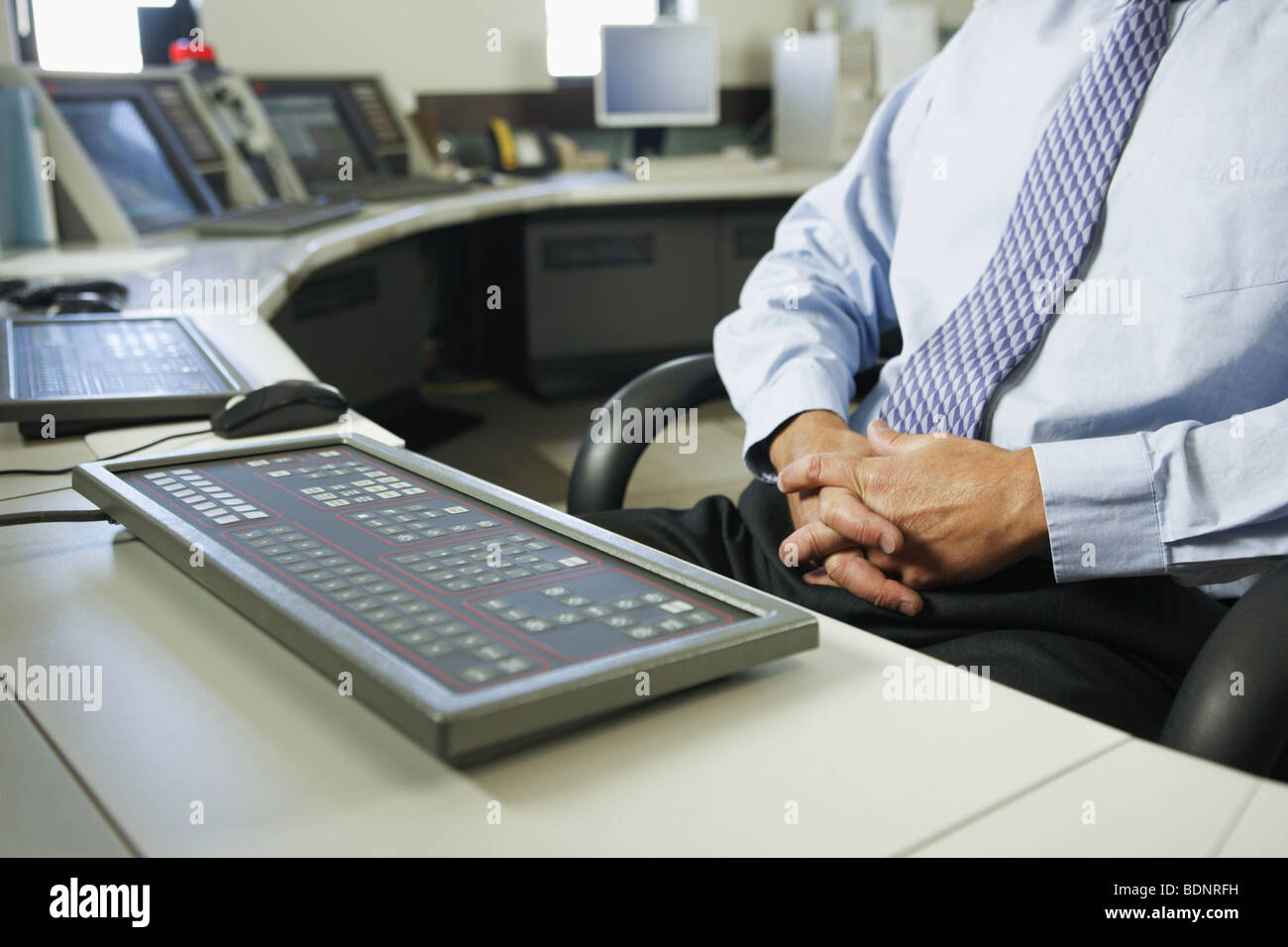 Operating engineer sitting in a control room Stock Photo - Alamy