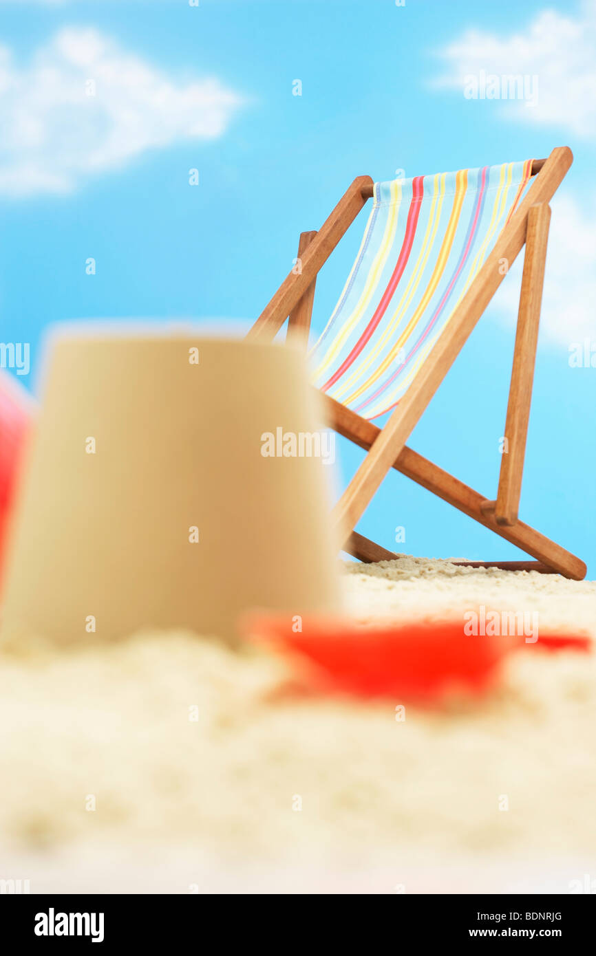 Deck chair behind and castle on beach Stock Photo - Alamy