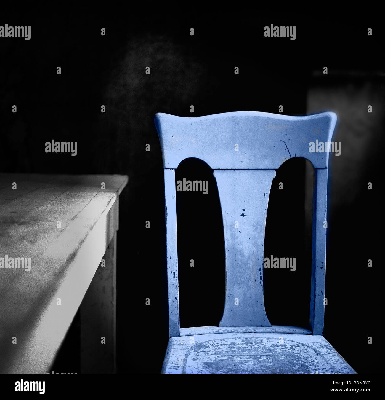 A blue chair beside a table Stock Photo - Alamy