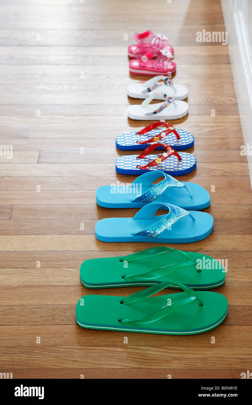 Row of flip-flops on floor, elevated view Stock Photo - Alamy
