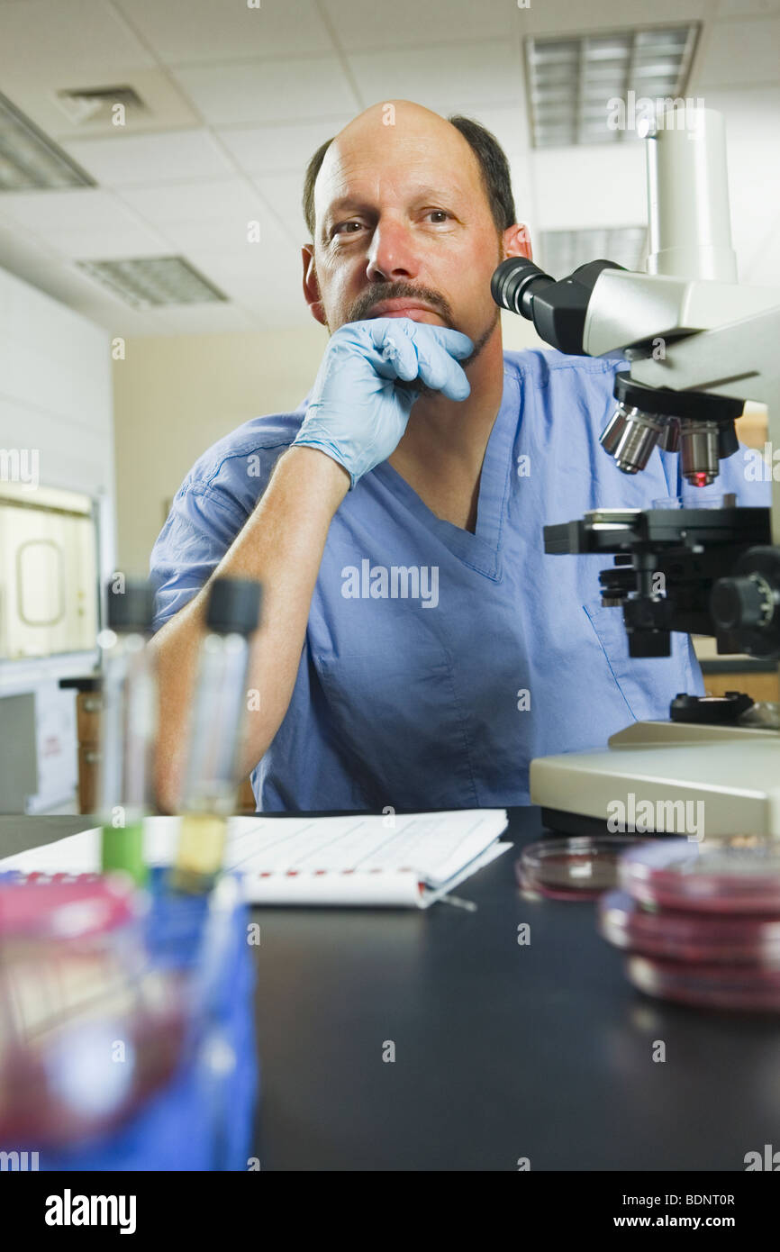 Scientist sitting in a laboratory and thinking Stock Photo - Alamy