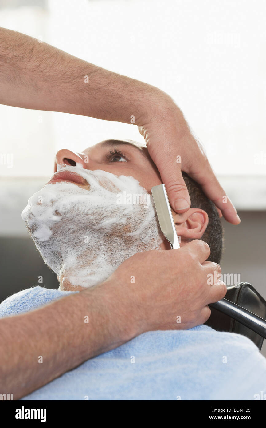Barber shaving man in barber shop, close-up Stock Photo - Alamy