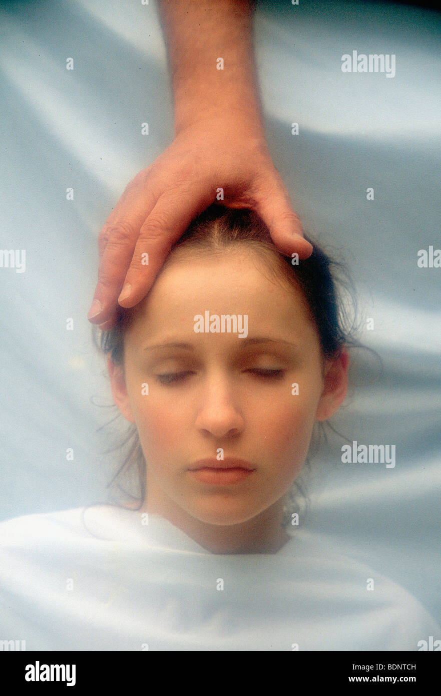 A hand placed on a child's head Stock Photo - Alamy