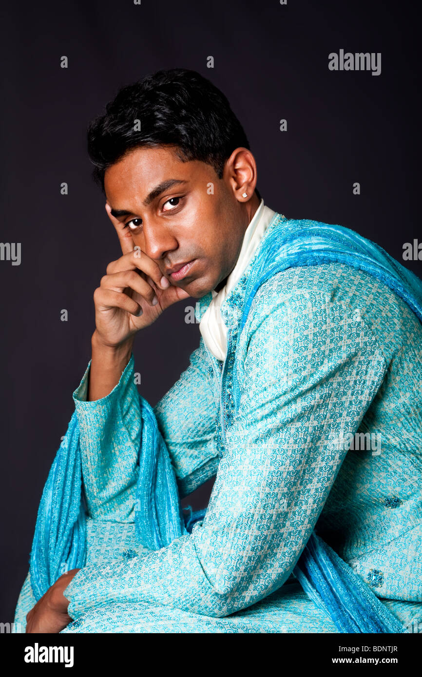 Beautiful face of an Indian Hindu young man with earing wearing blue ...