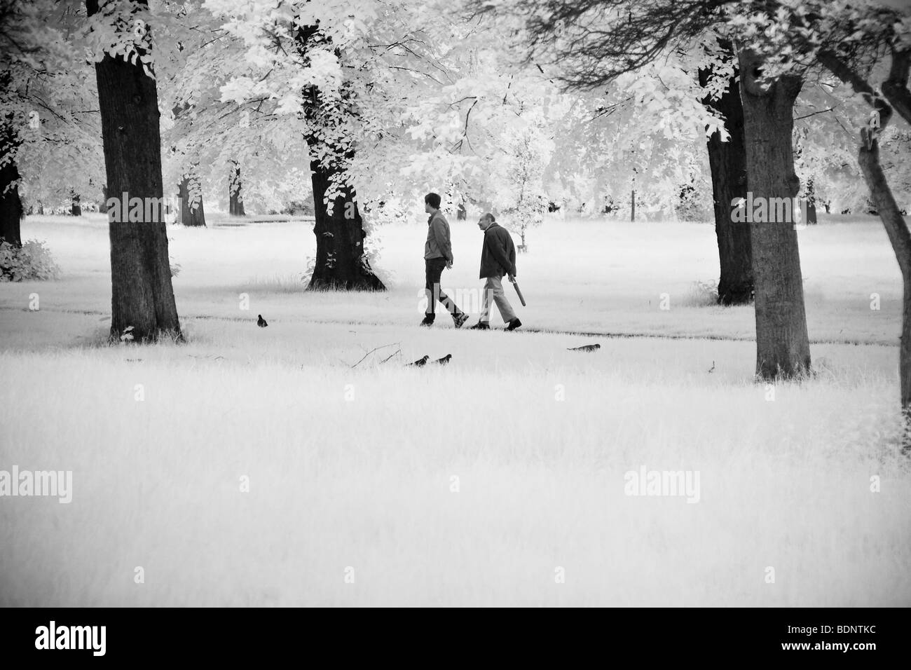 Two men walking Black and White Stock Photos & Images - Alamy