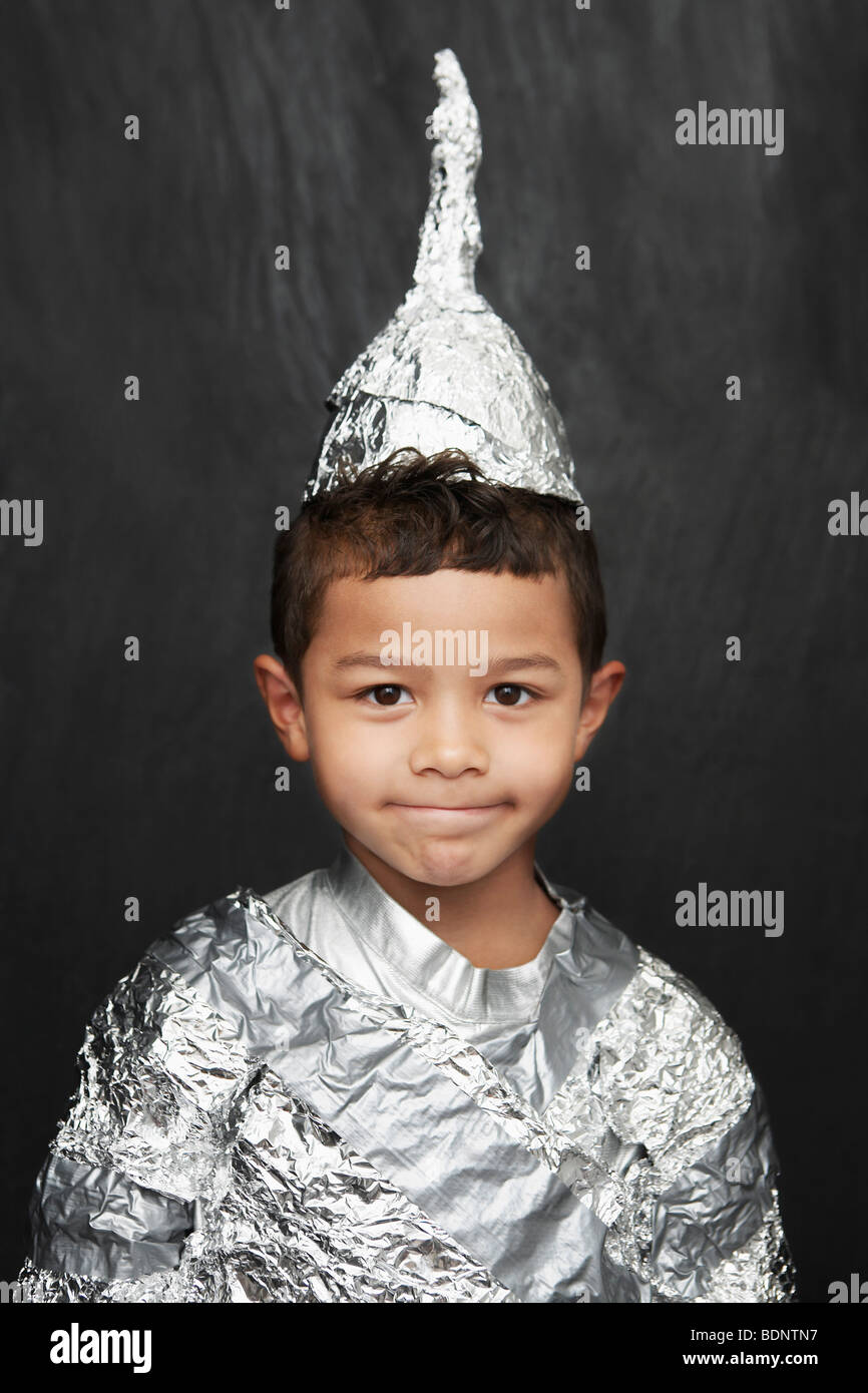Portrait of young boy (5-6) in aluminum foil knight costume, studio ...