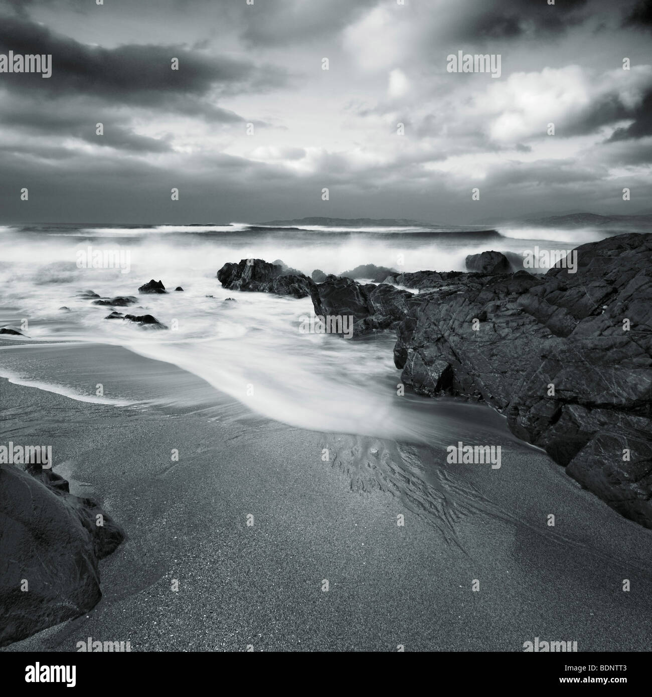 A peaceful cove with sand and surf Stock Photo - Alamy