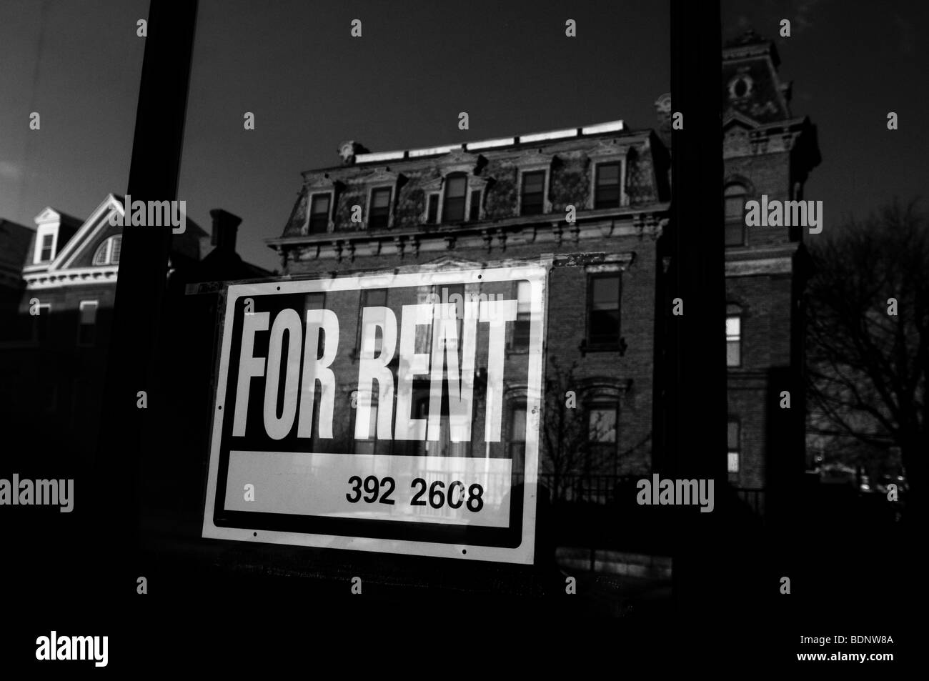 A for rent sign and a reflection of an old building in the USA Stock ...