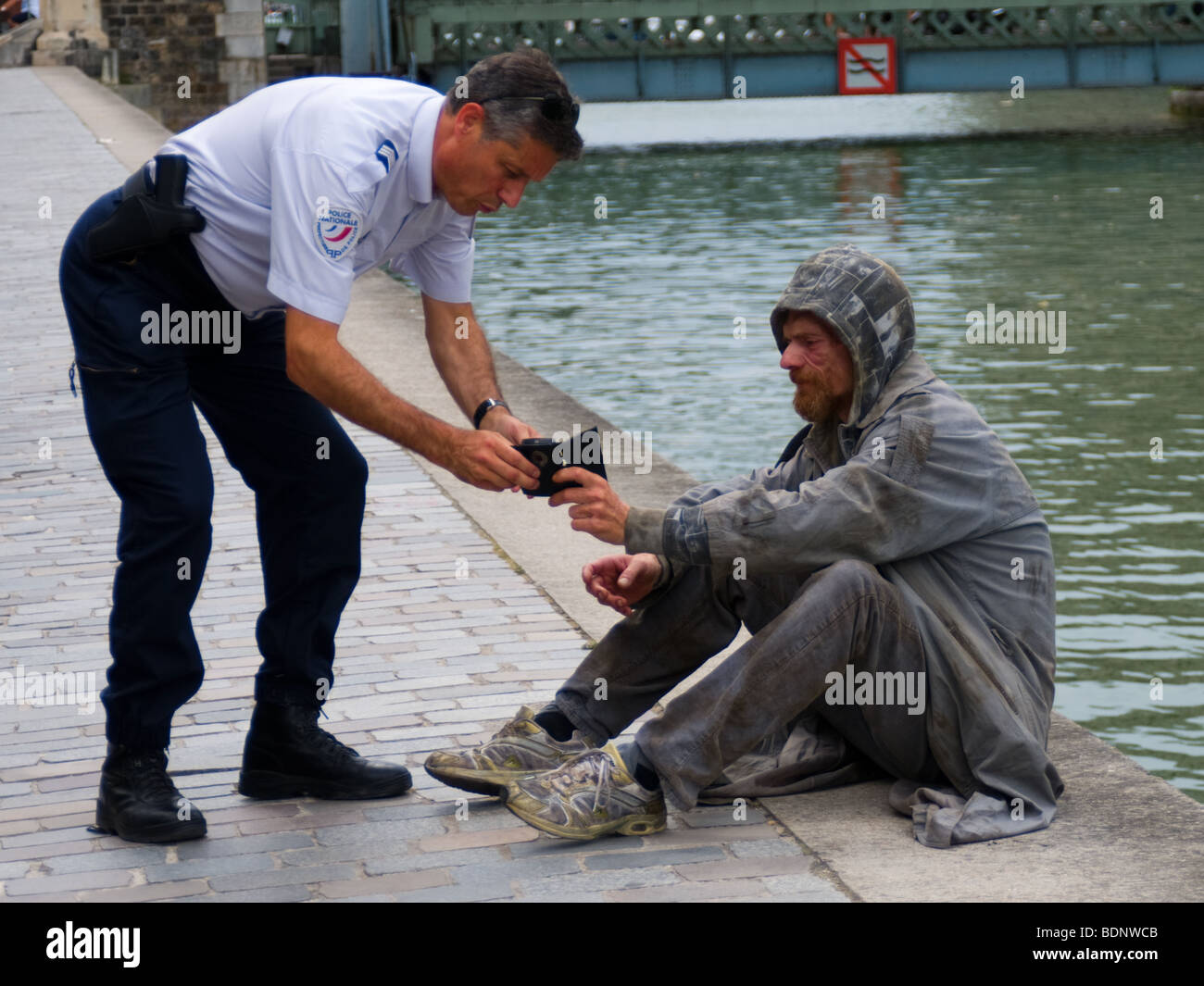An actor playing a homeless person, French police talking to the ...