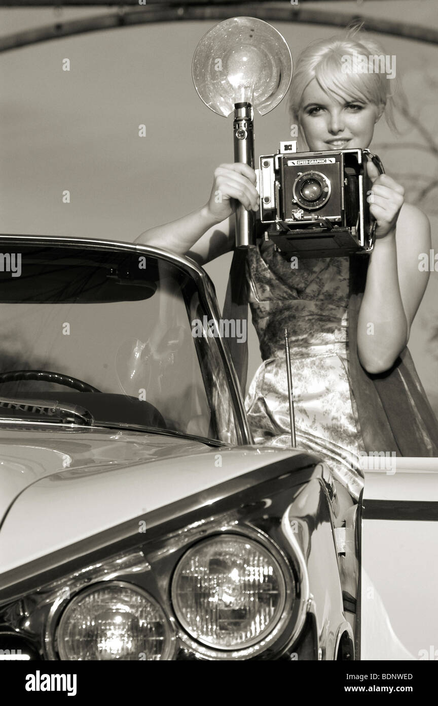 A fashion model holding an old camera Stock Photo - Alamy