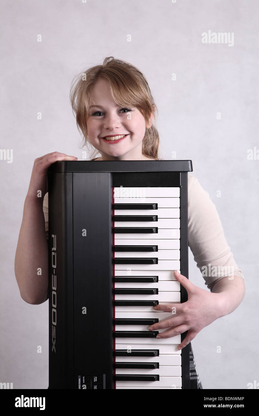 Beautiful young teenage musician with her keyboard Stock Photo - Alamy