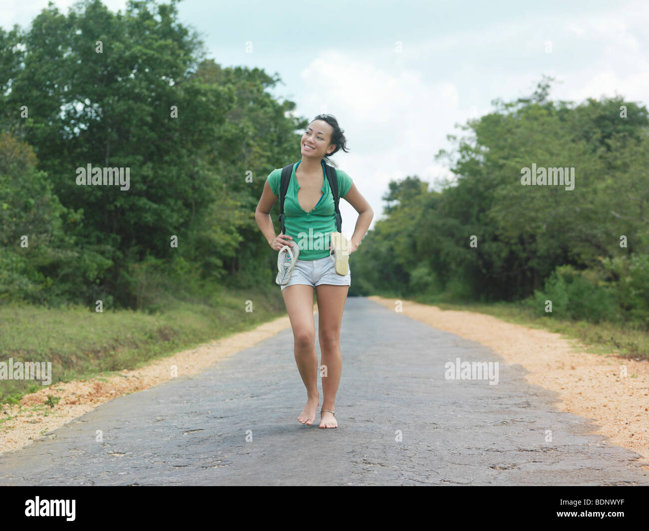 Young woman barefoot, walking rural road, smiling Stock Photo - Alamy Young woman barefoot, walking rural road, smiling Stock Photo - Alamy