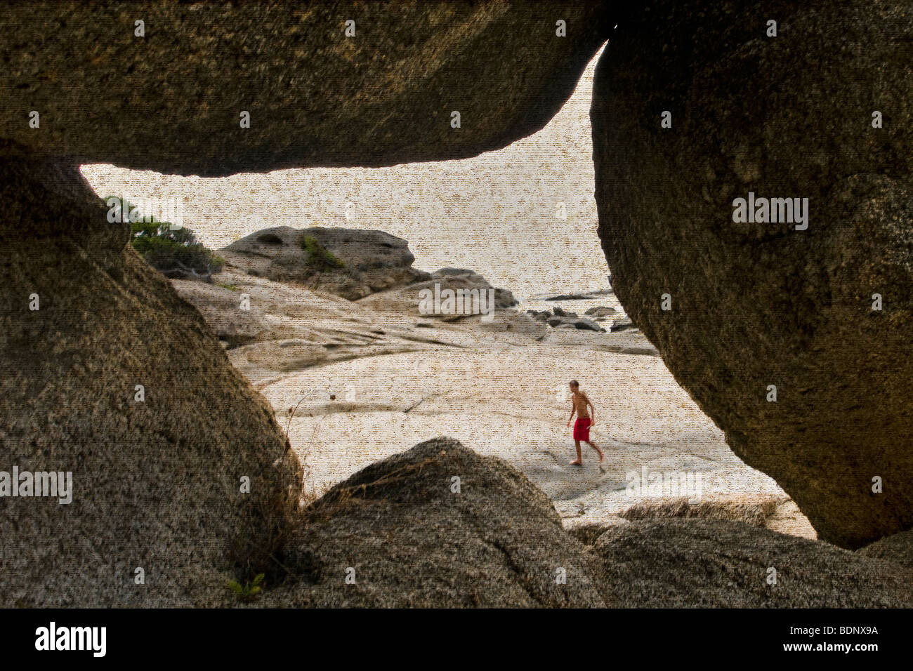 A lone figure of a teenager on a beach Stock Photo - Alamy