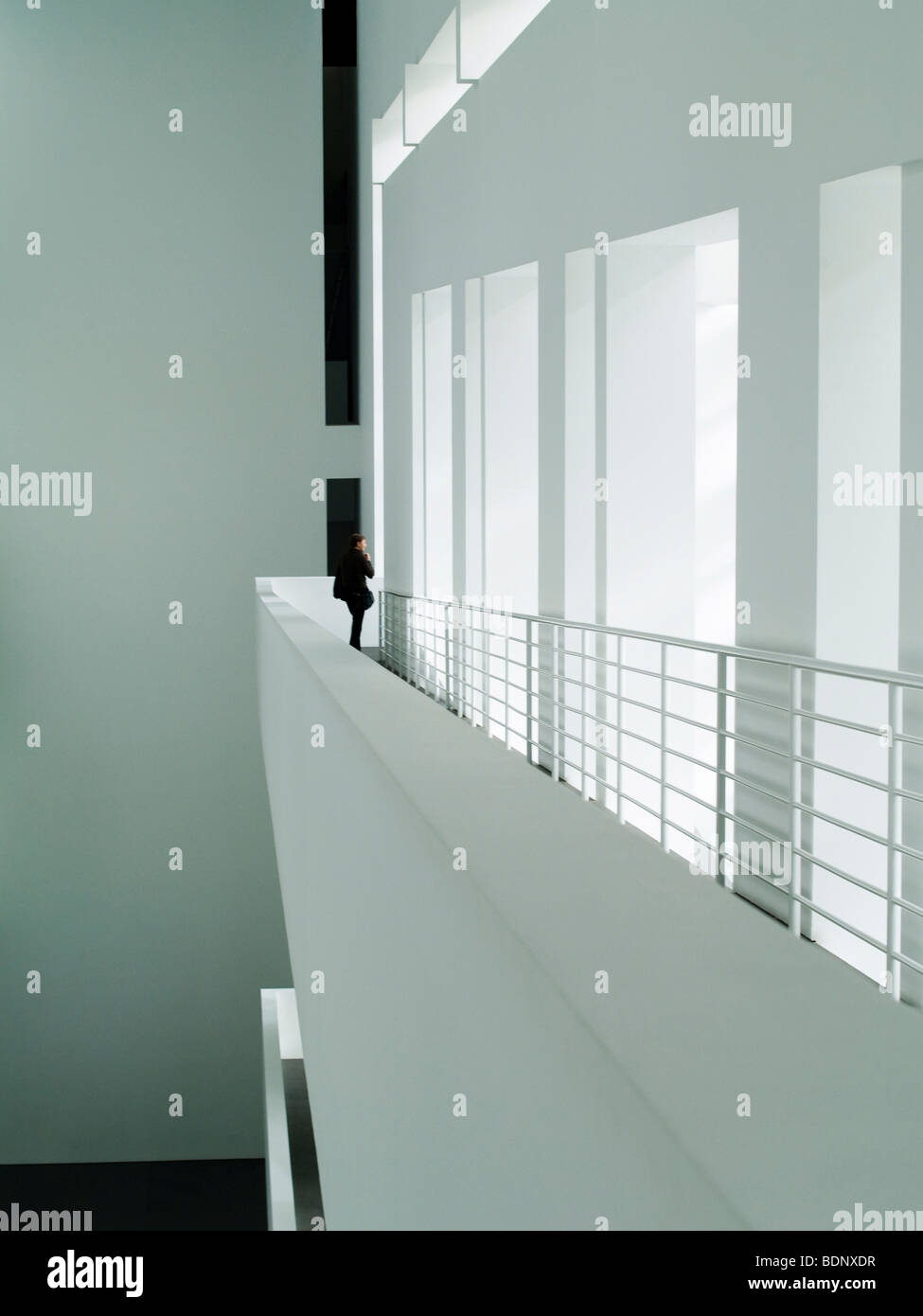 A white interior or a large building with one figure Stock Photo - Alamy