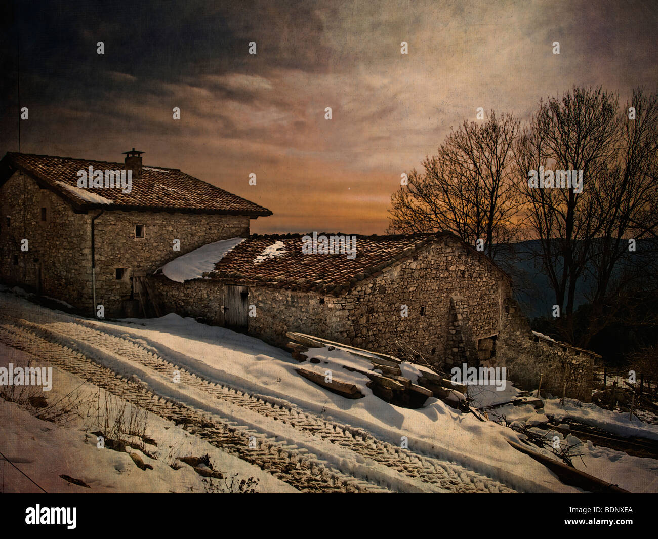 A winter scene with snow of an old house at dusk Stock Photo - Alamy