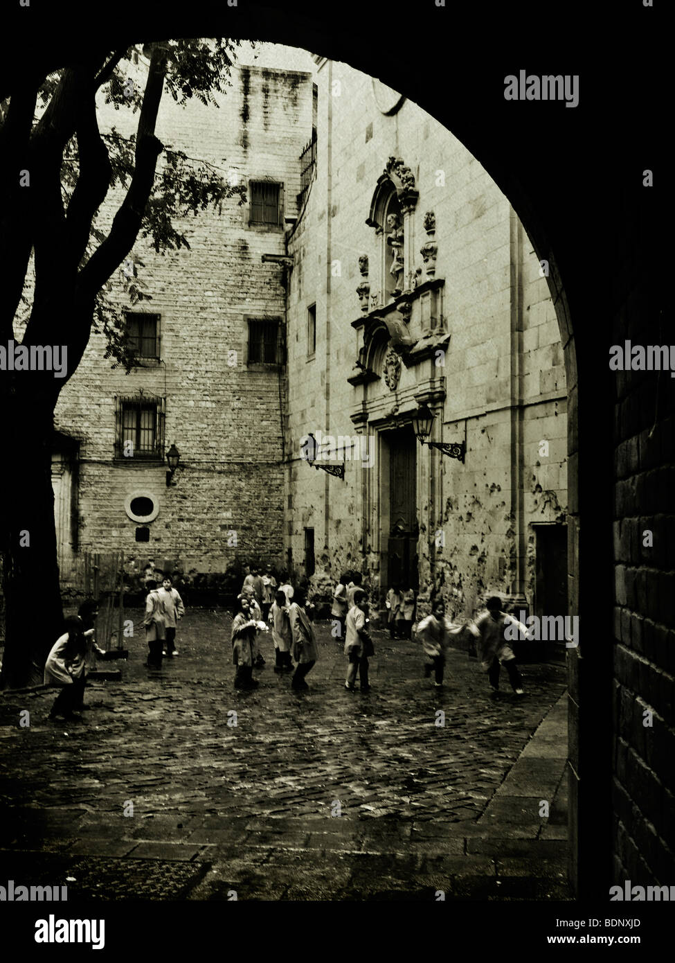 Young children playing in a courtyard Stock Photo - Alamy