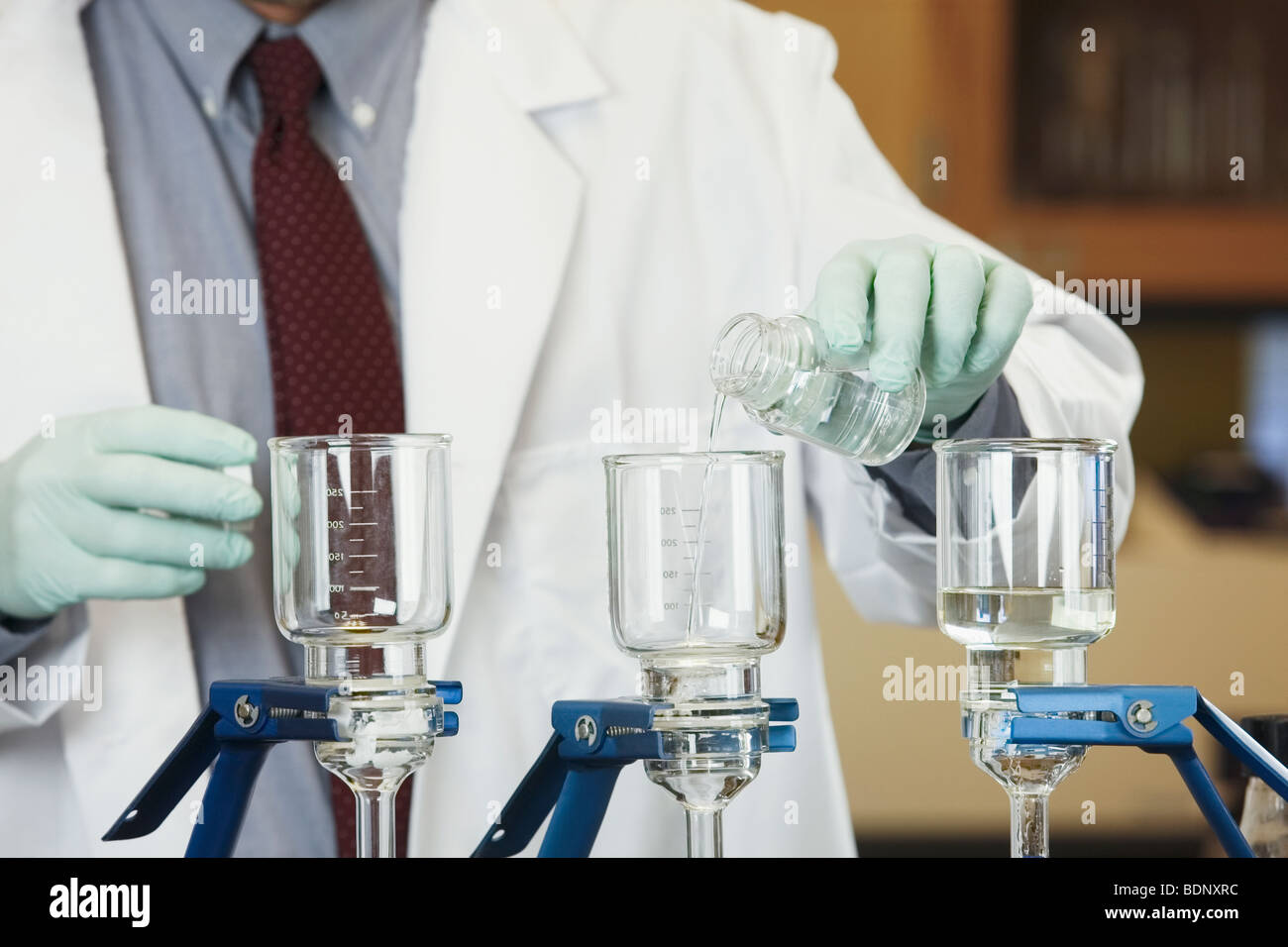 Scientist filtering a sample Stock Photo - Alamy
