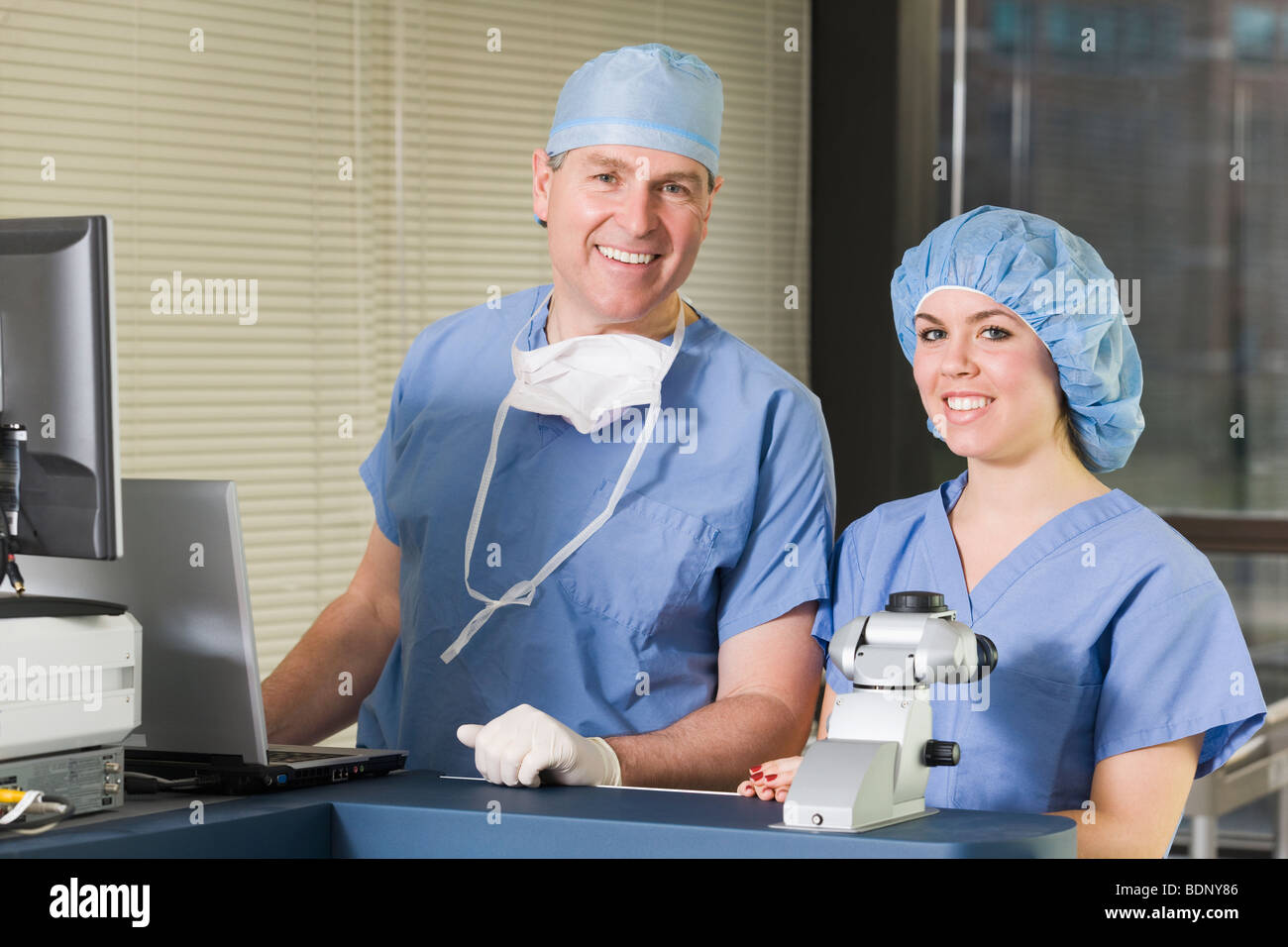 Two surgeons working on a laser machine Stock Photo - Alamy