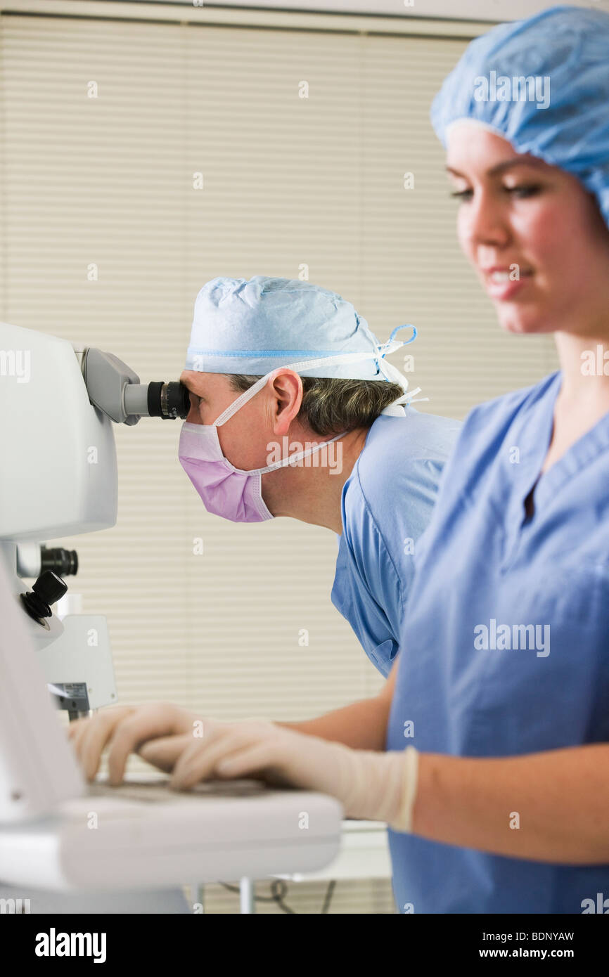 Two surgeons working on a laser machine Stock Photo - Alamy