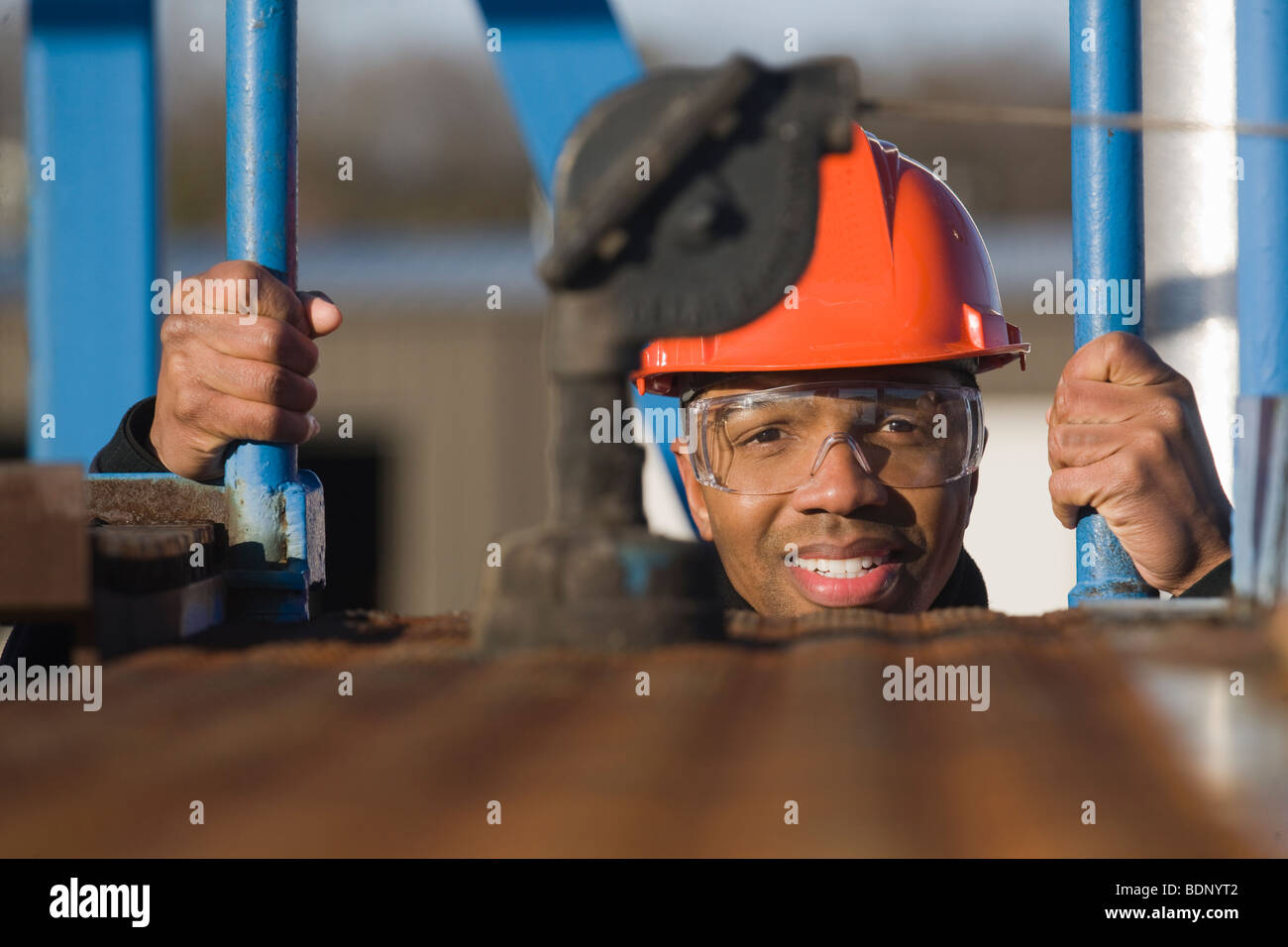 Engineer climbing a ladder Stock Photo - Alamy